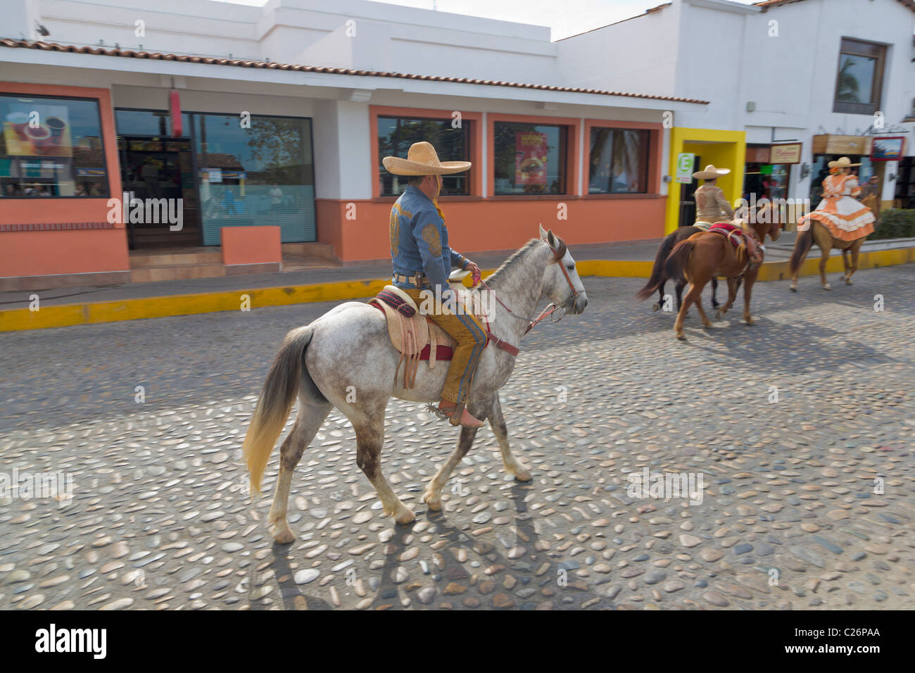Mexicans on horseback riding through Puerto Vallarta, Jalisco, Mexico ...