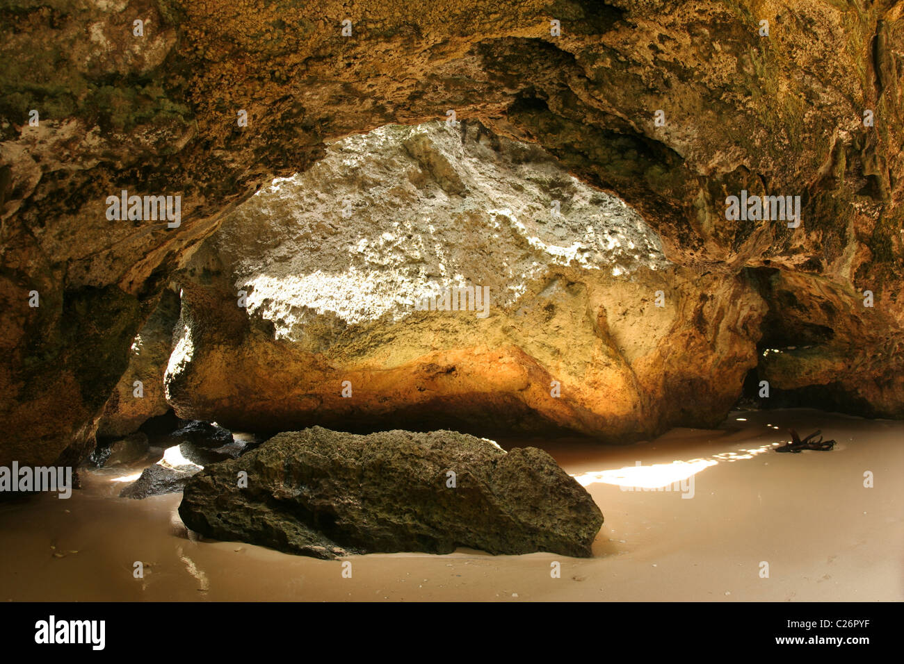 Light shining through cliff rocks at Ulu Watu Stock Photo - Alamy