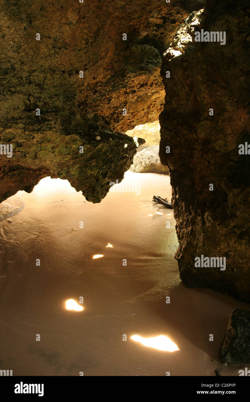 Specs of light shining through cliff rocks Stock Photo - Alamy