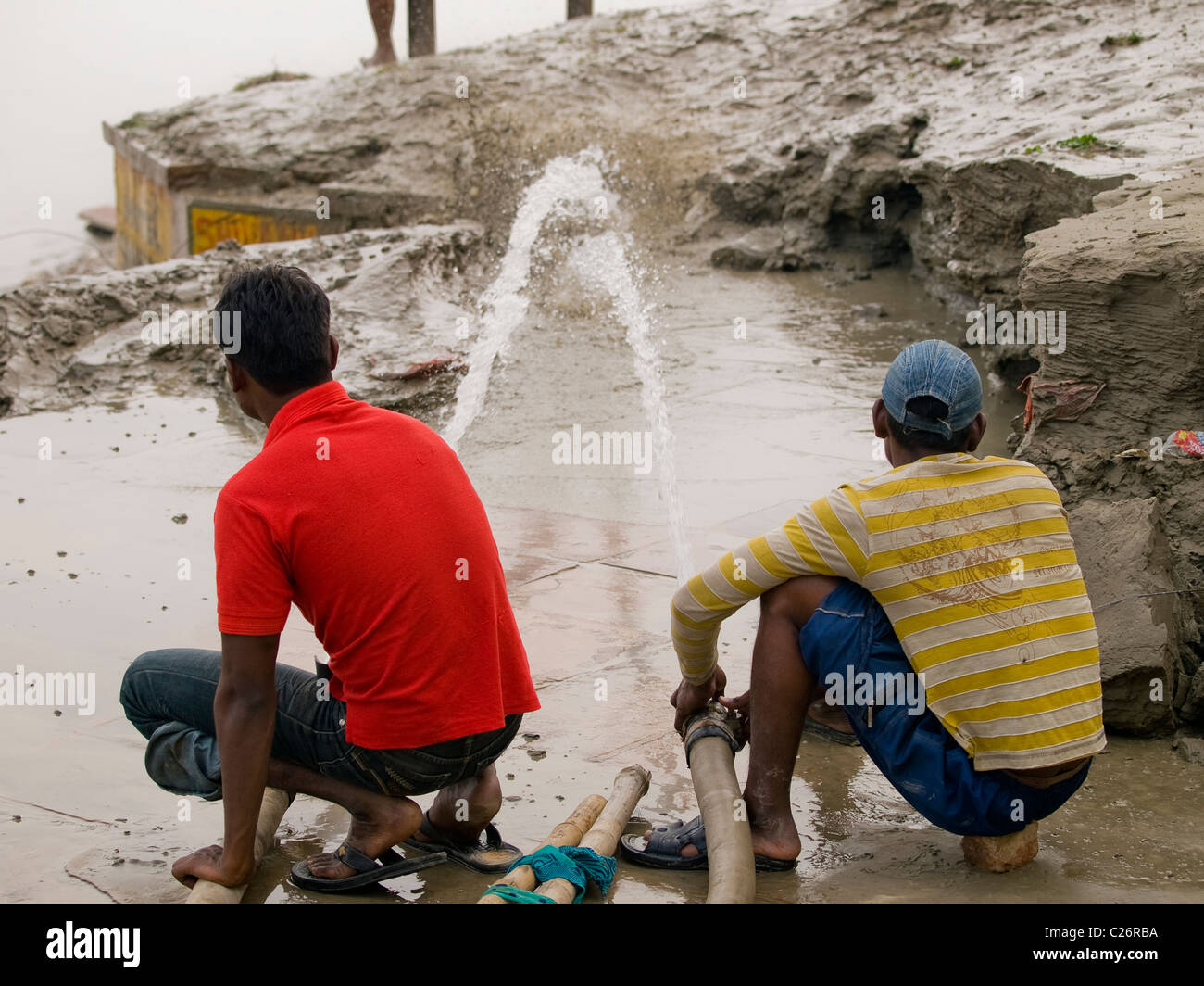 Two men cleaning the ghats in Varanasi after the floodings of the wet ...
