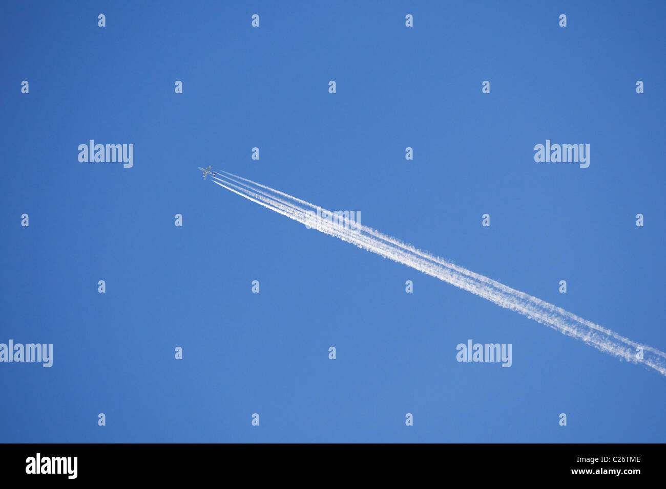 Contrail against blue sky Stock Photo - Alamy