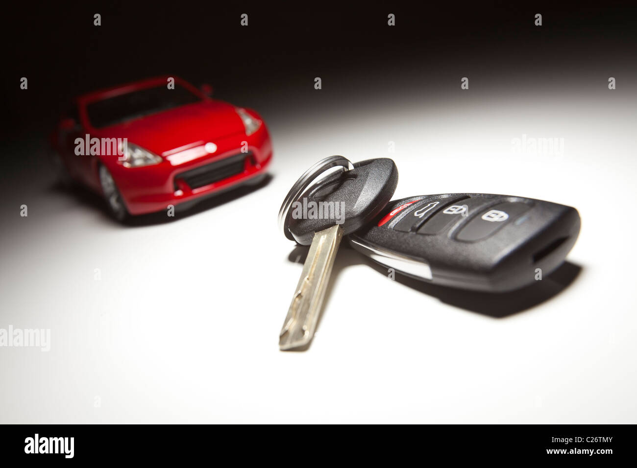 Car Keys and Sports Car in the Background Under Spot Light Stock Photo ...