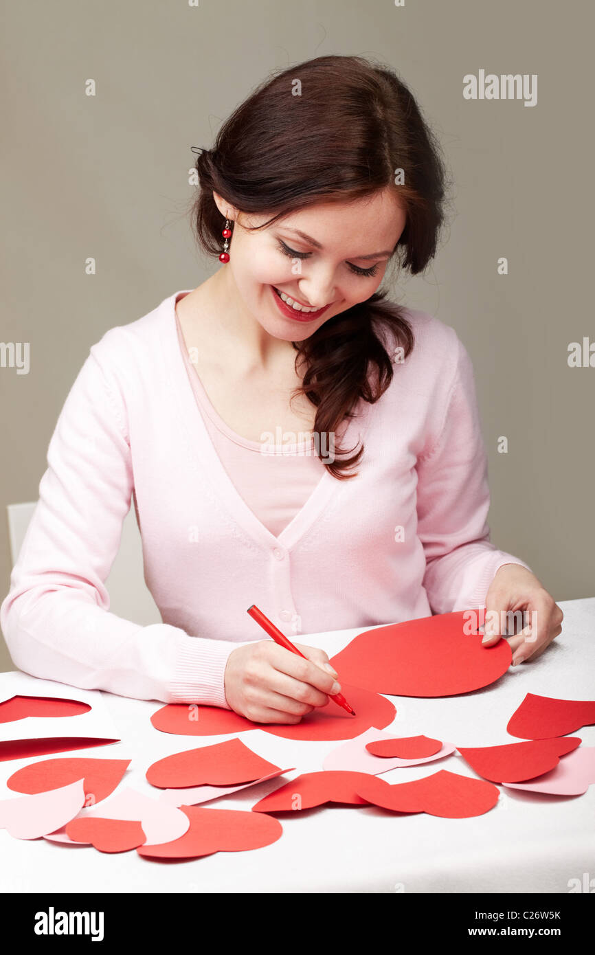 Portrait of a woman signing valentine cards Stock Photo - Alamy