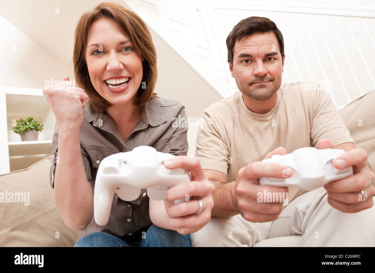 Man and woman married couple having fun playing computer console game ...