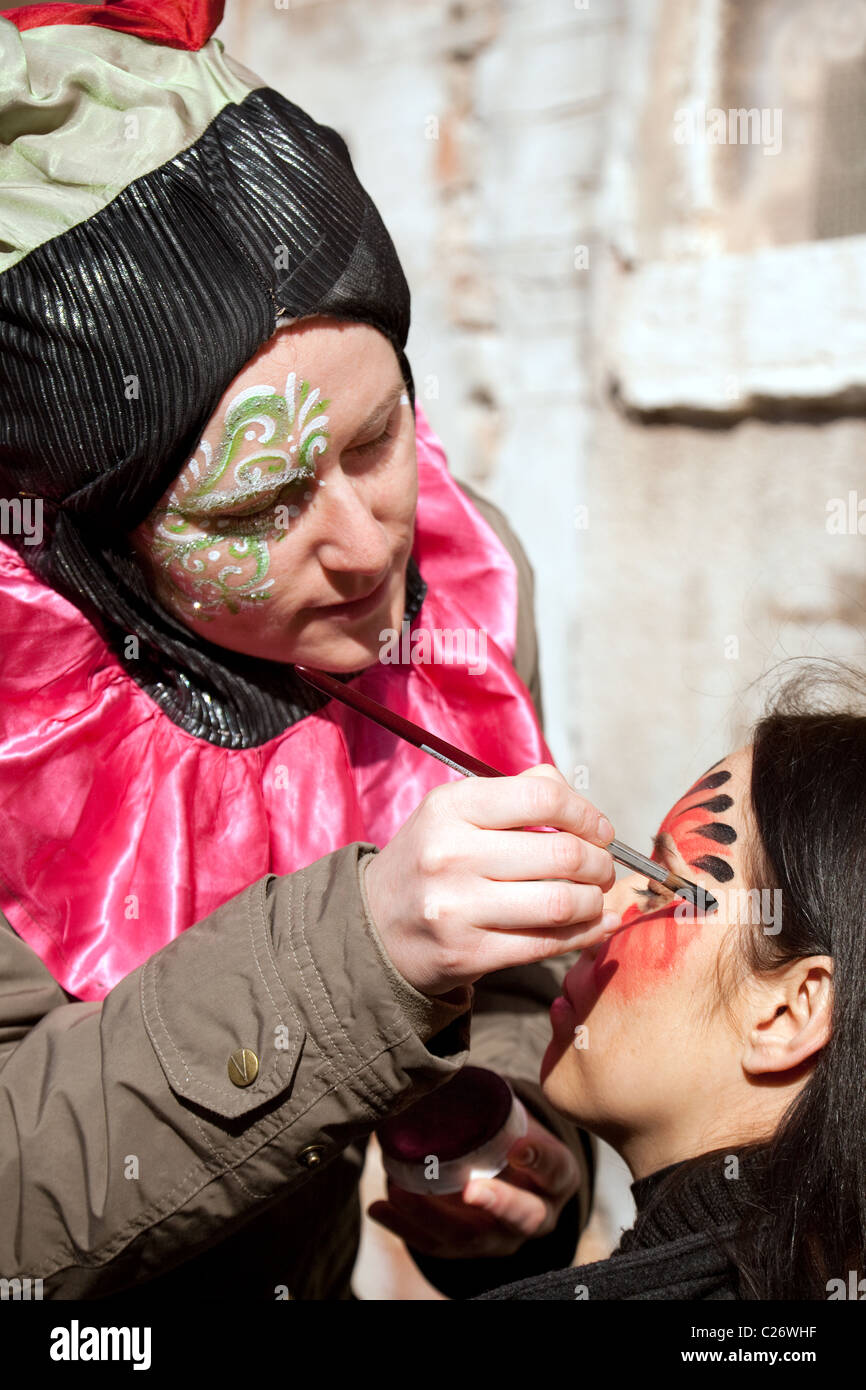 A young woman having her face painted, Venice, Italy Stock Photo - Alamy