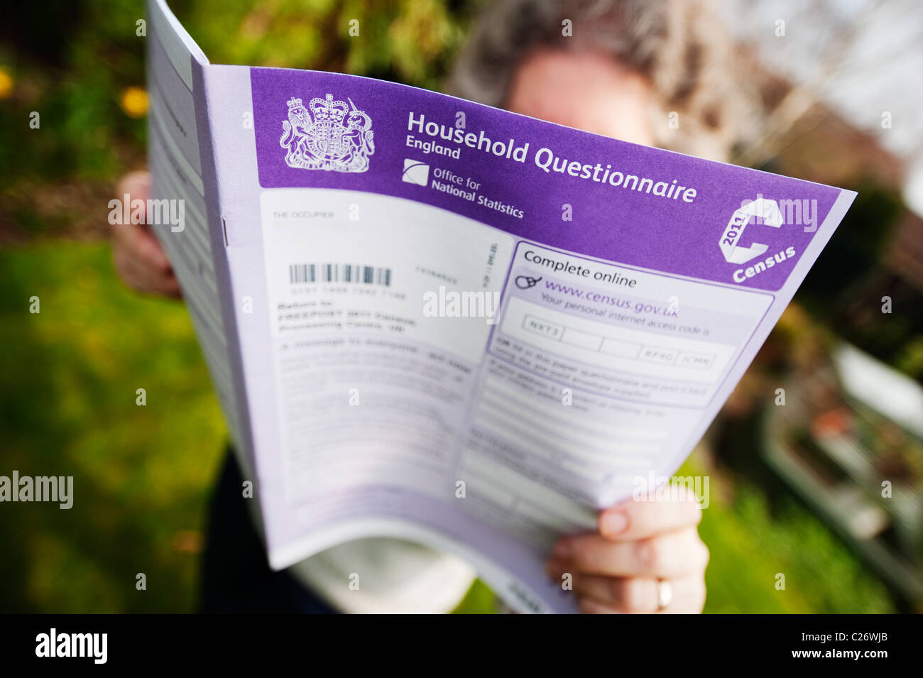 Woman reading Official 2011 UK Census form Stock Photo - Alamy