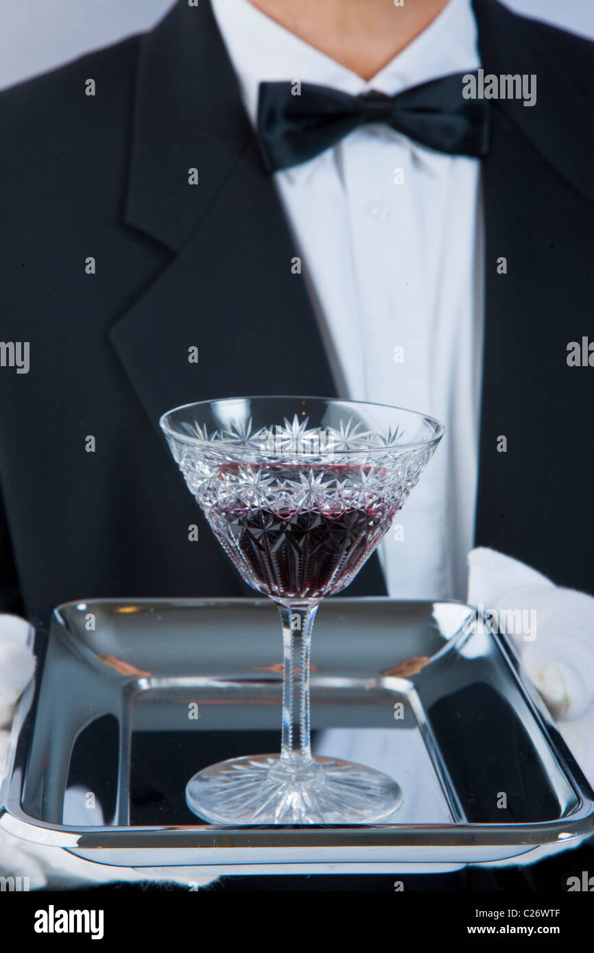 Waiter Holding Tray with Glass of Port Stock Photo - Alamy
