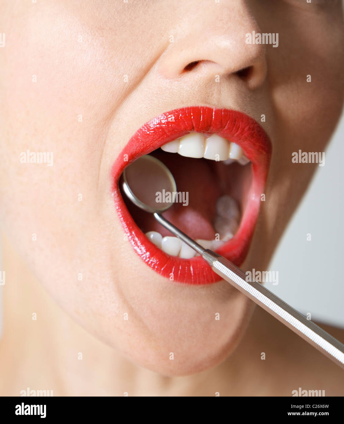 Woman inspecting teeth mirror hi-res stock photography and images - Alamy