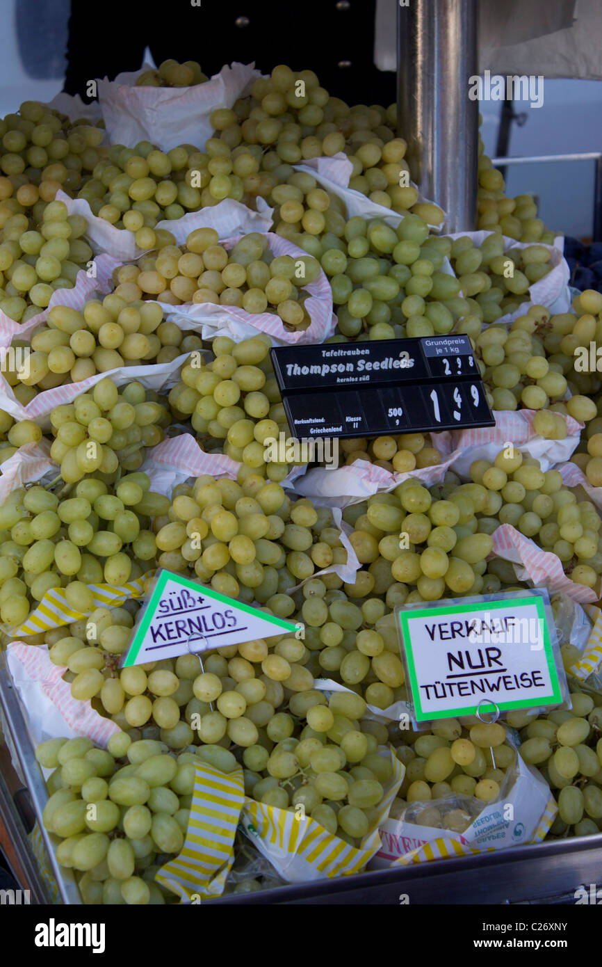 Bunches of white grapes on a german food market stall in Munich city ...