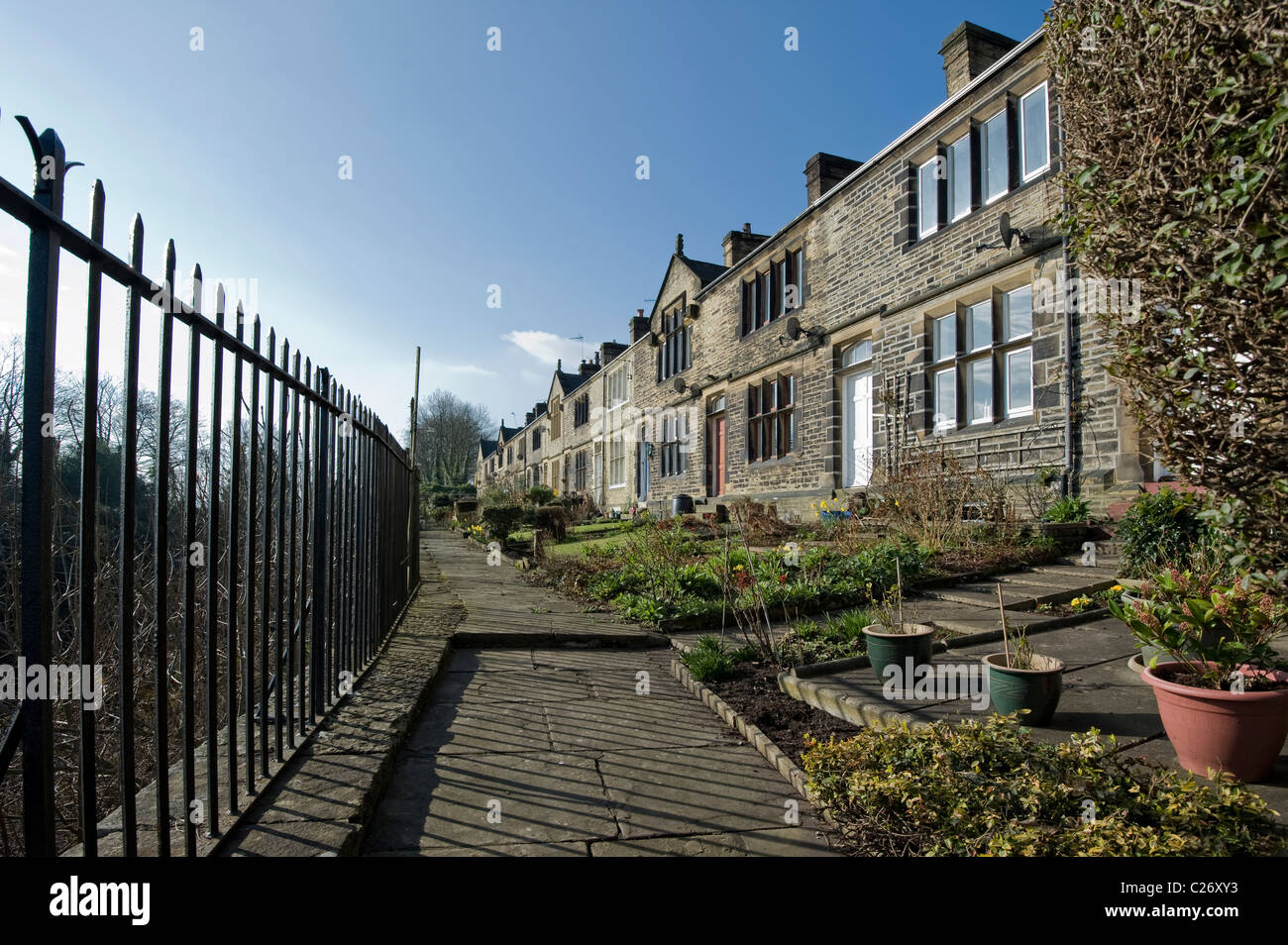 Stone built victorian housing with metal fencing on stone flags Stock ...