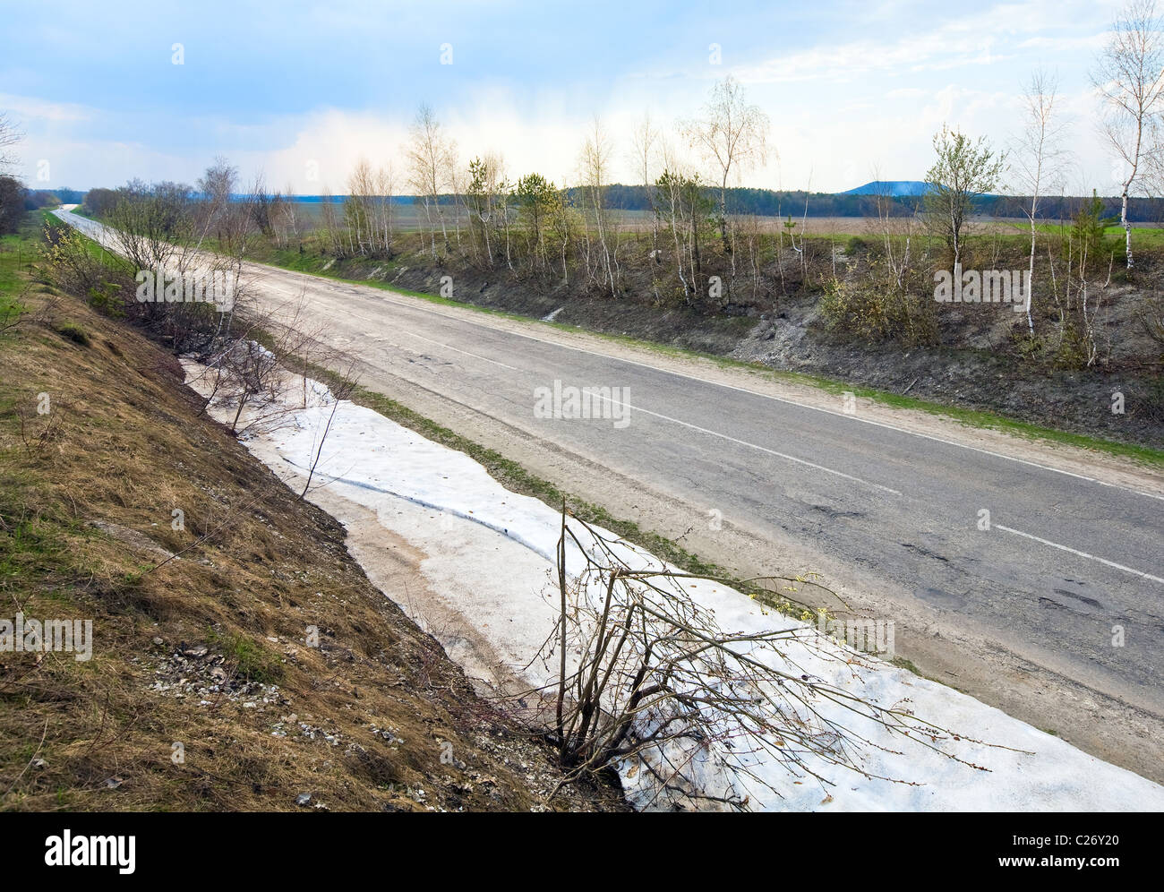spring dull landscape with country road and melting snow at side Stock ...