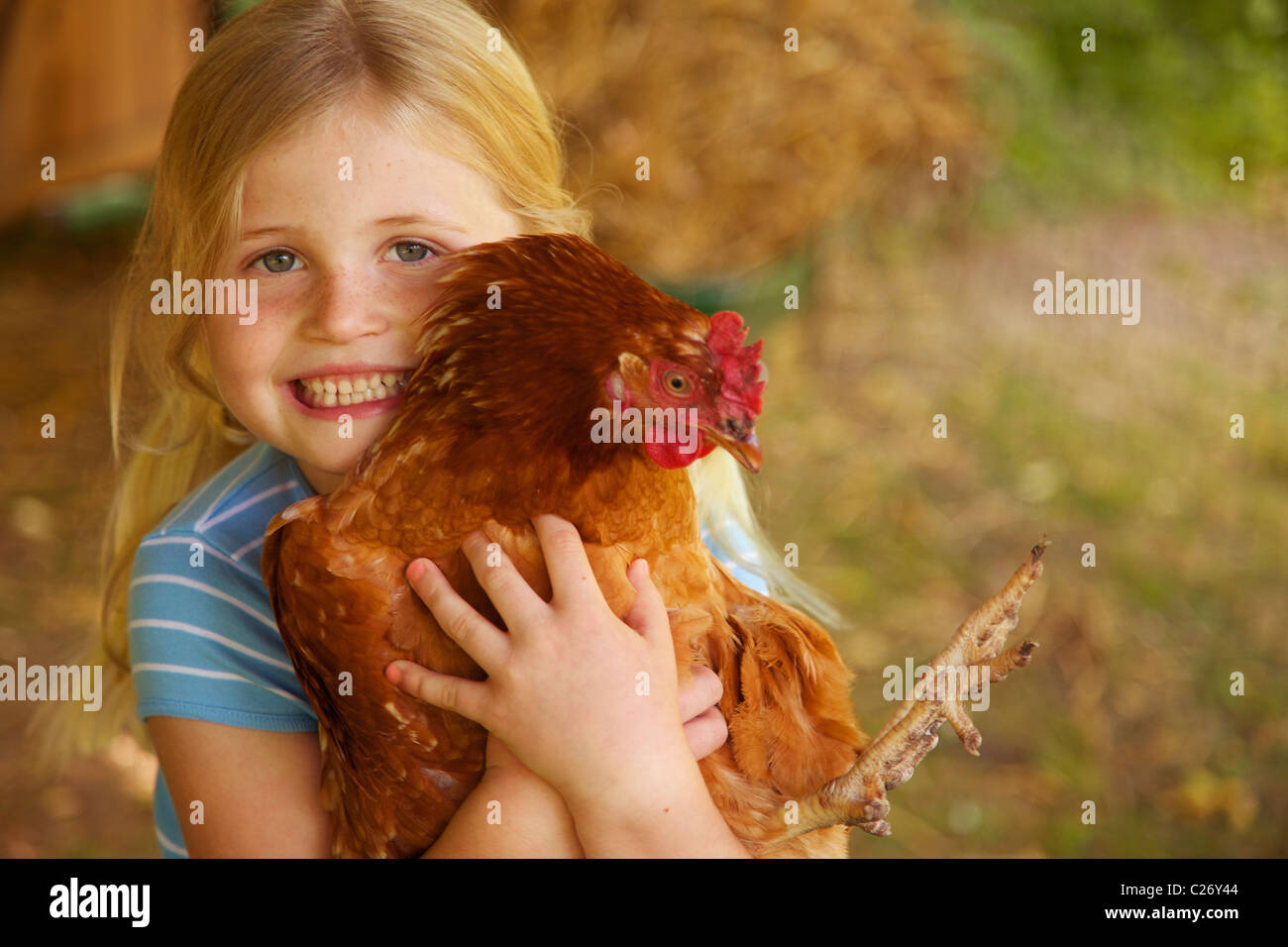 Smiling Girl Hugging Chicken Stock Photo - Alamy