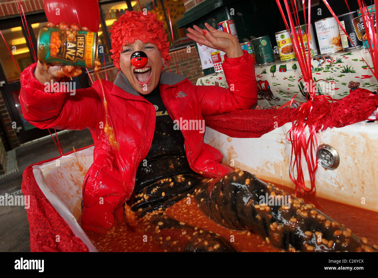 A school teacher pictured in a bath of baked beans to raise money for ...