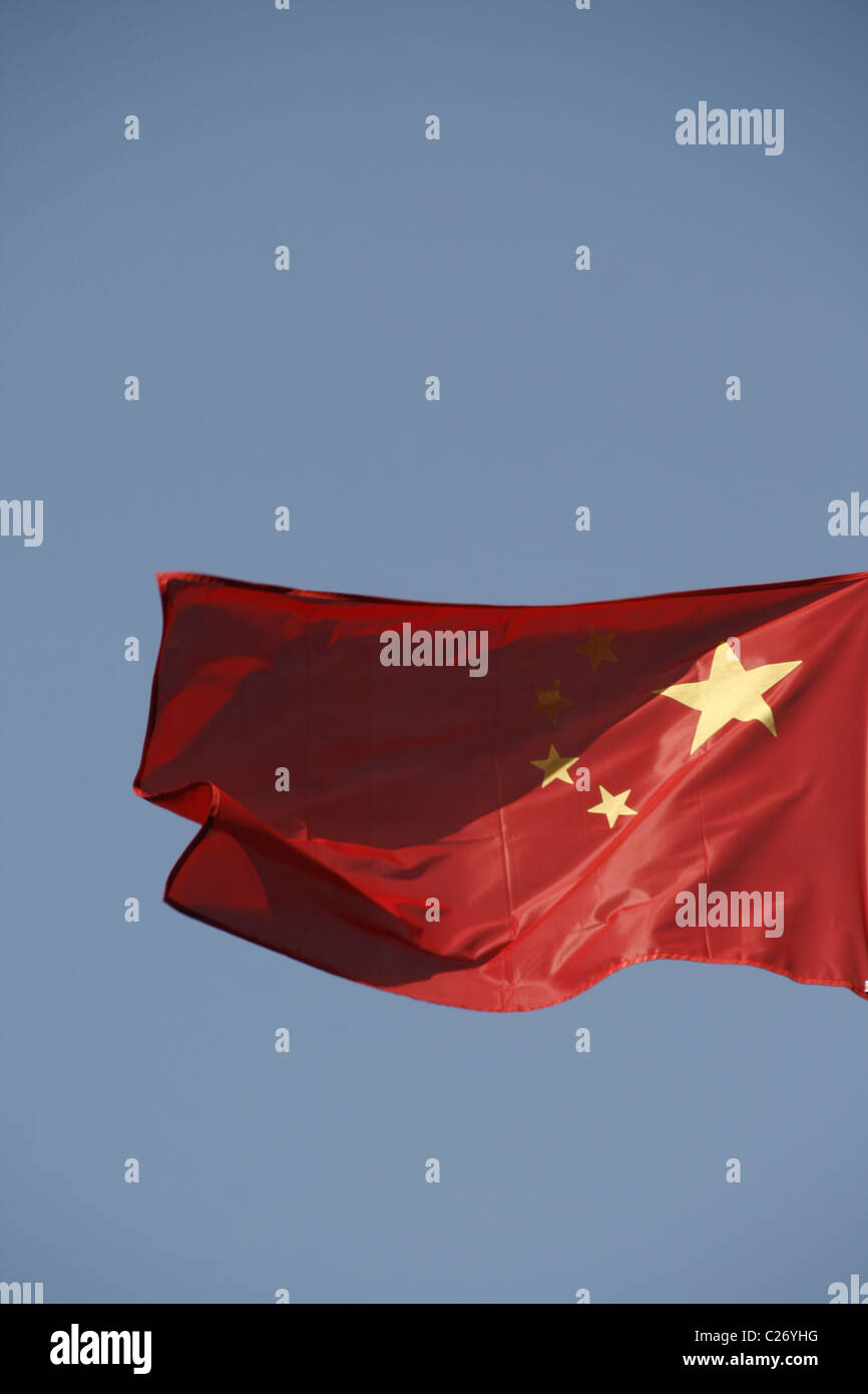 one chinese flag flying in wind and blue sky Stock Photo - Alamy