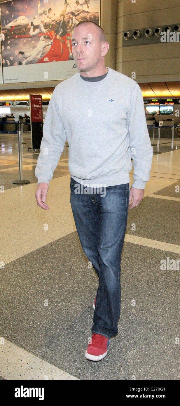 Film director Guy Ritchie arrives at LAX to board a BA flight to London ...
