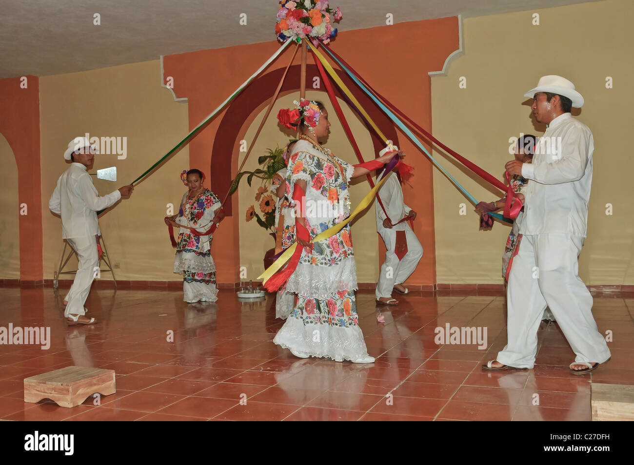 mexican women and men performing traditional dance on stage with ribbon ...