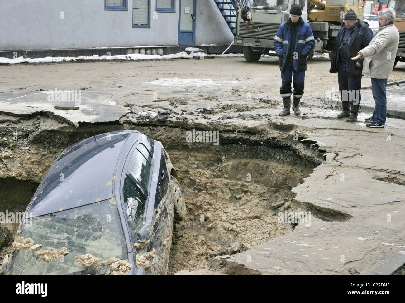 Russia, St.Petersburg a car inside the collapsed hole of a road Russia ...