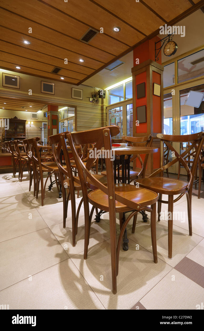 Cafe interior with wooden furniture, lighting equipment and decoration ...