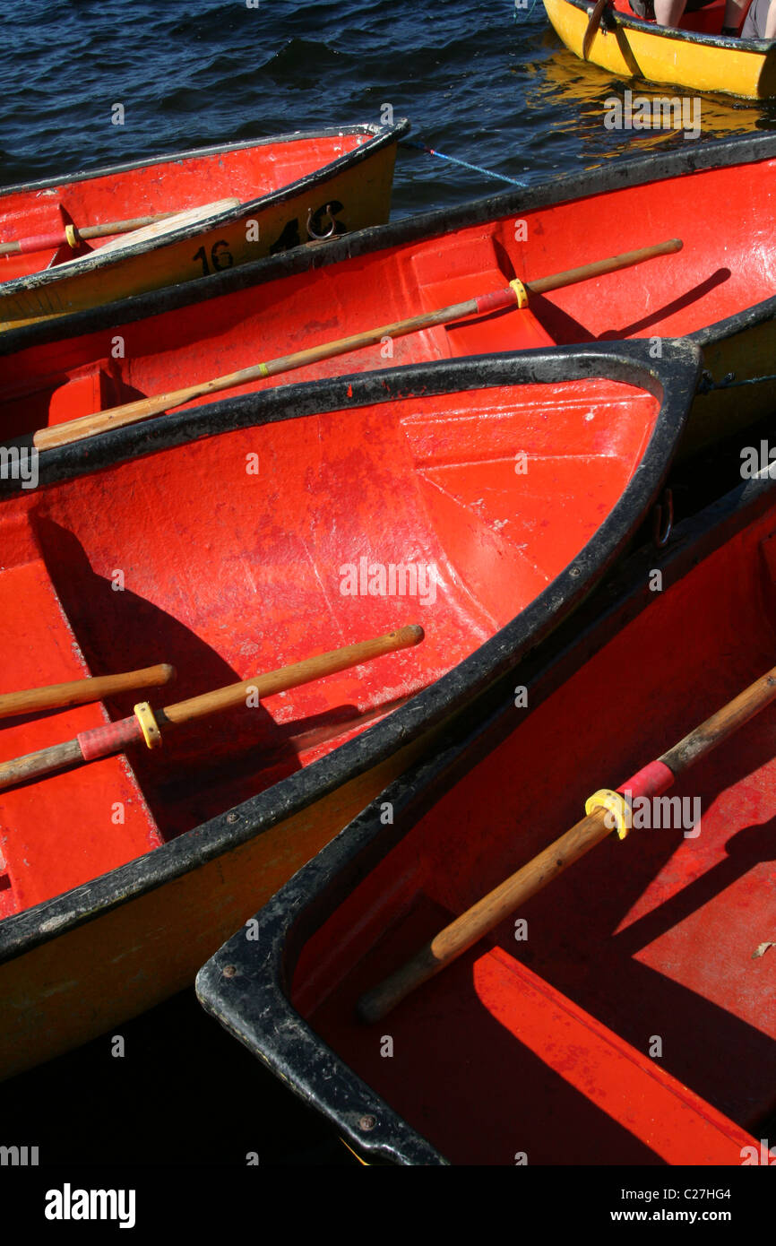 close up of boat on river lake row rowing boats red empty vacant oar ...