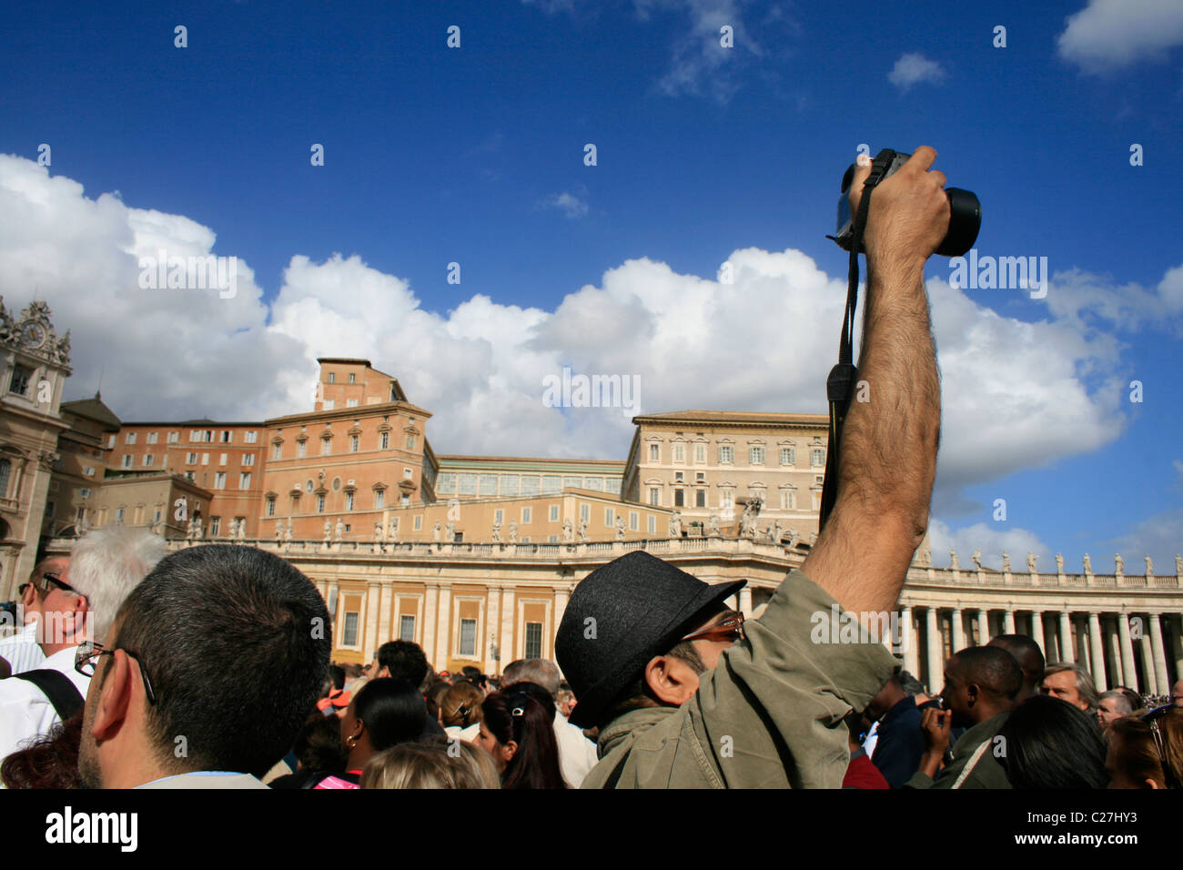 pilgrim taking photo photograph above crowd in the vatican square rome ...