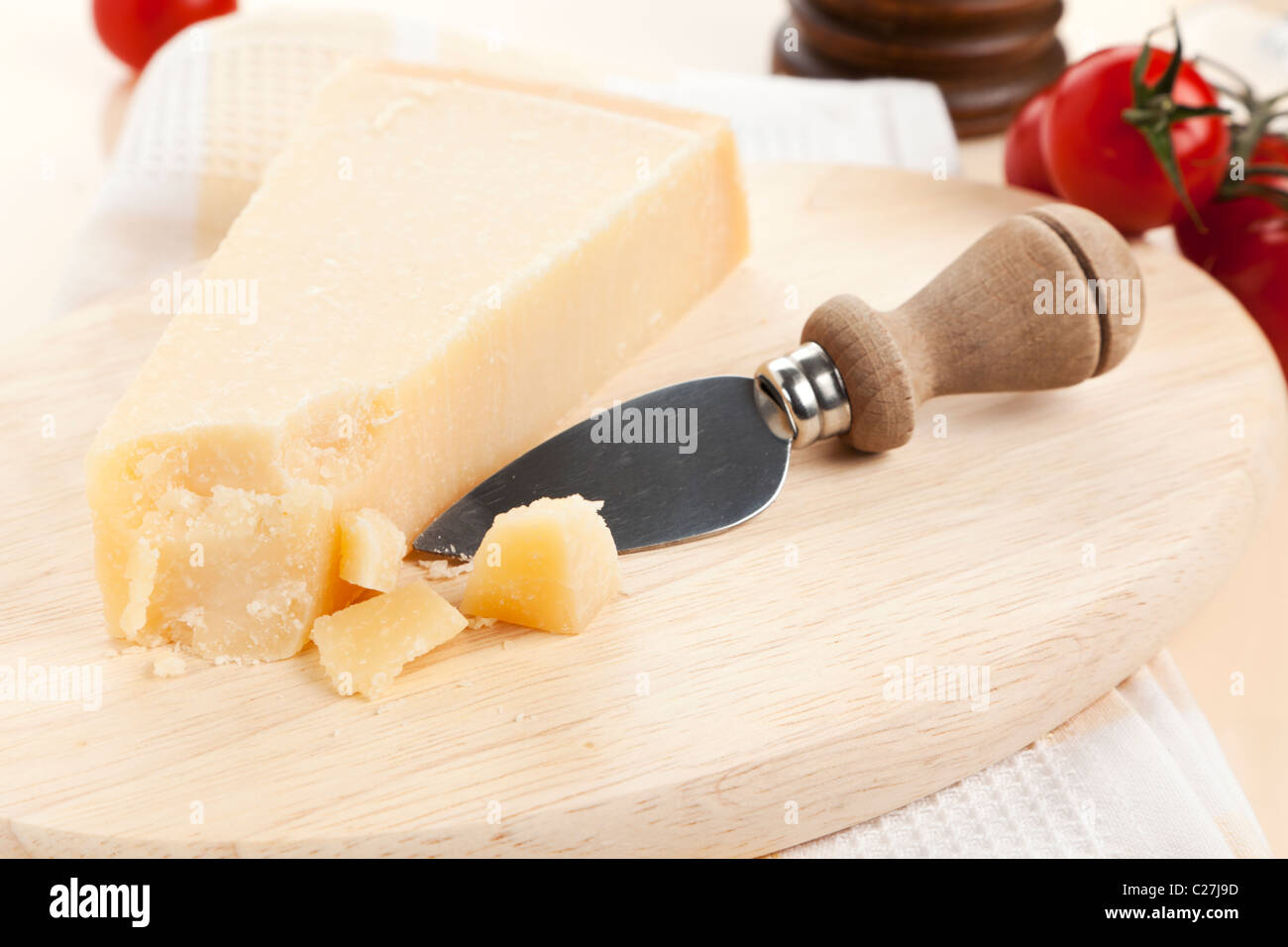 parmesan cheese and knife on wooden platter Stock Photo - Alamy