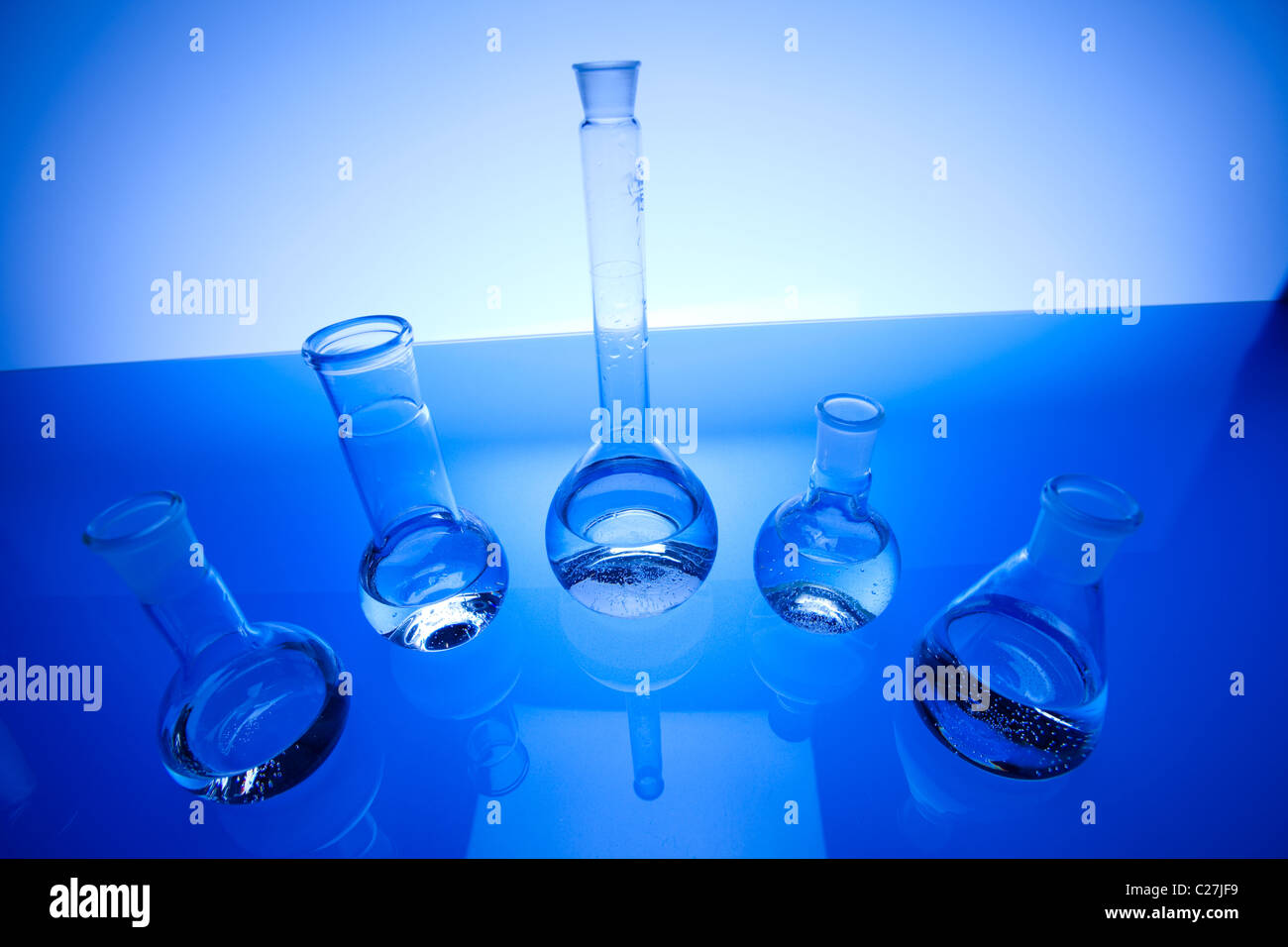 Laboratory glass in blue scenery Stock Photo - Alamy