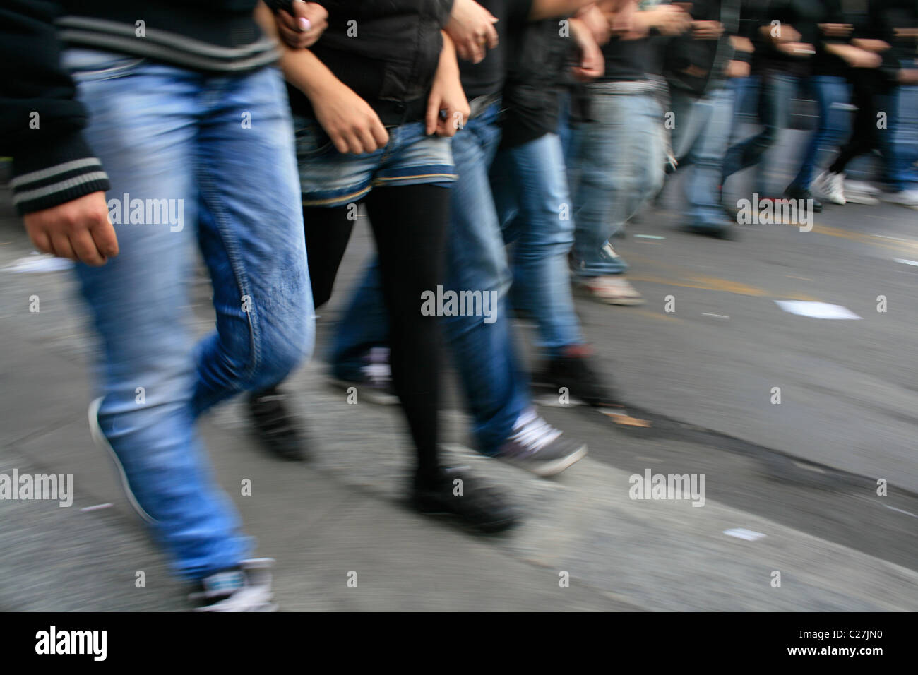 group of teenagers protesters walking in a line at protest demo rally ...