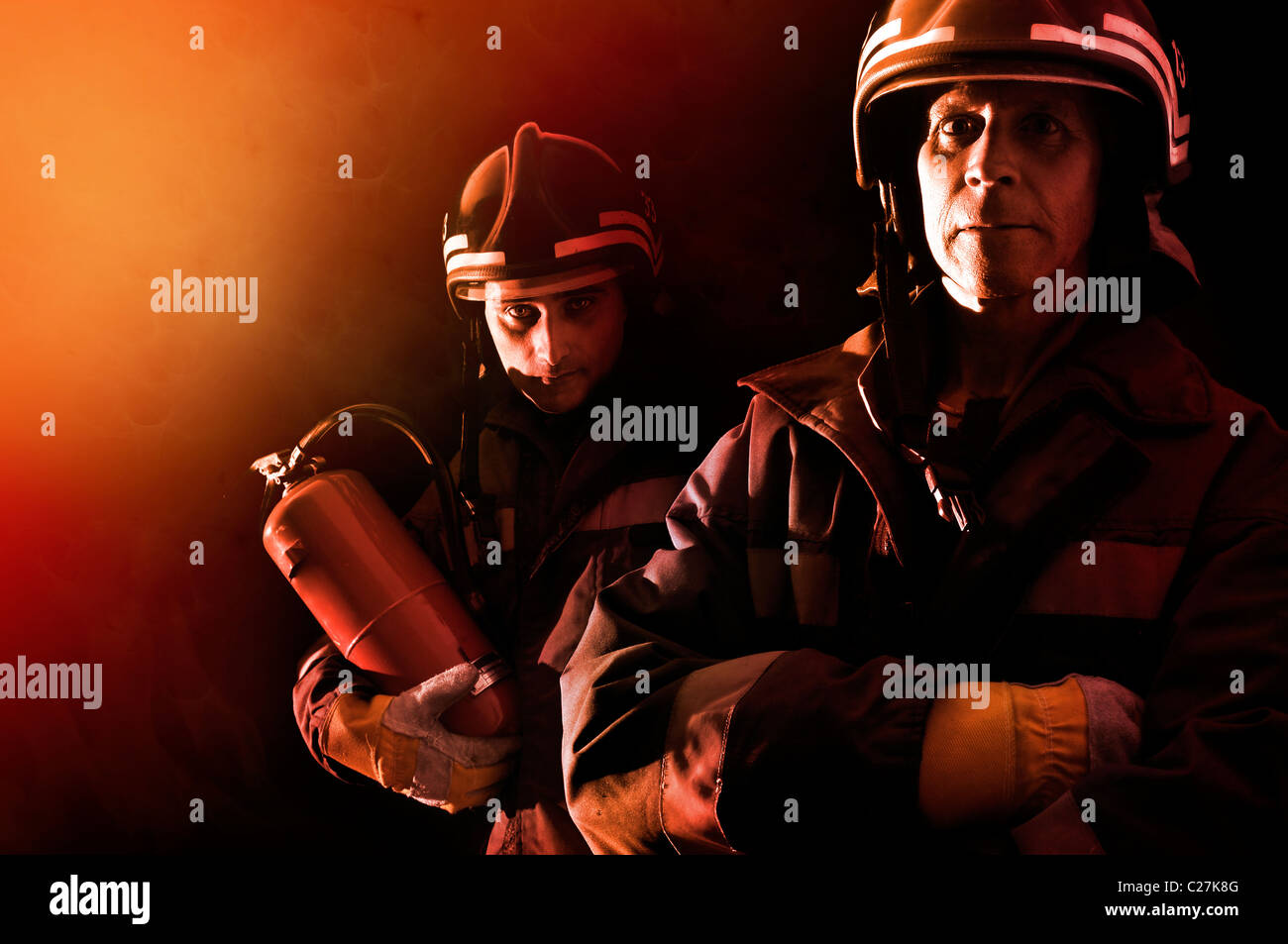 Dramatic image of firemen team in uniform Stock Photo - Alamy