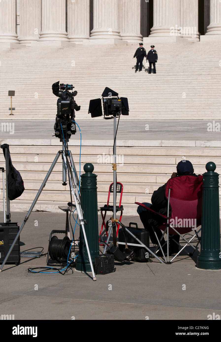 The news media wait outside the US Supreme Court building in Washington ...