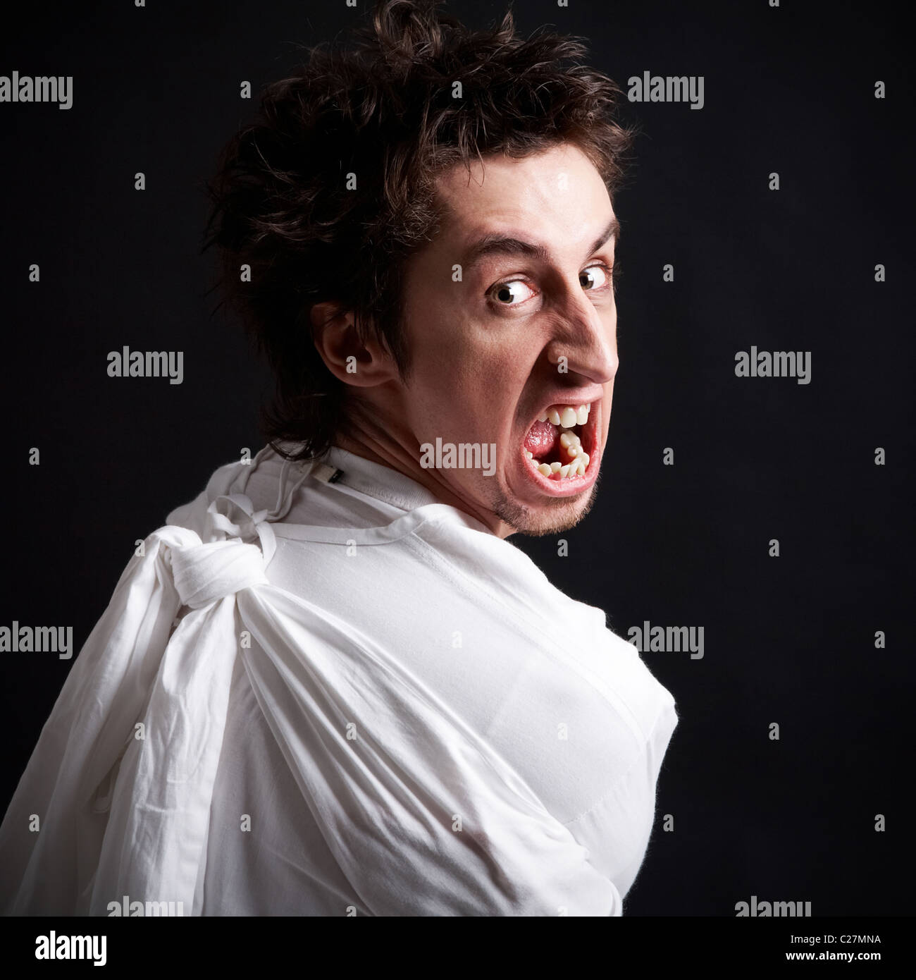 Insane man in strait-jacket screaming in isolation Stock Photo - Alamy