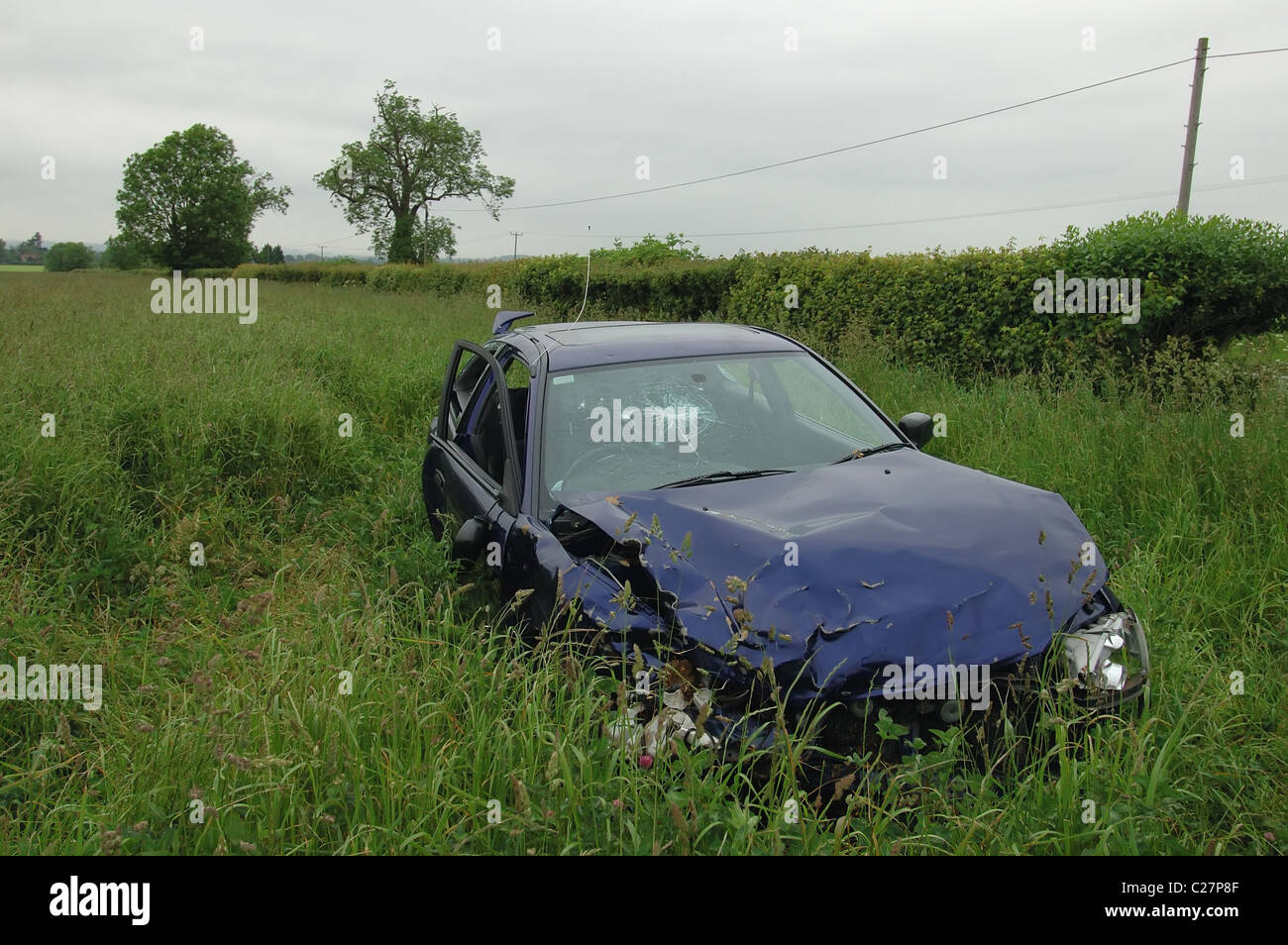 A crashed blue car lies abandoned in a field off the Foss Way near ...