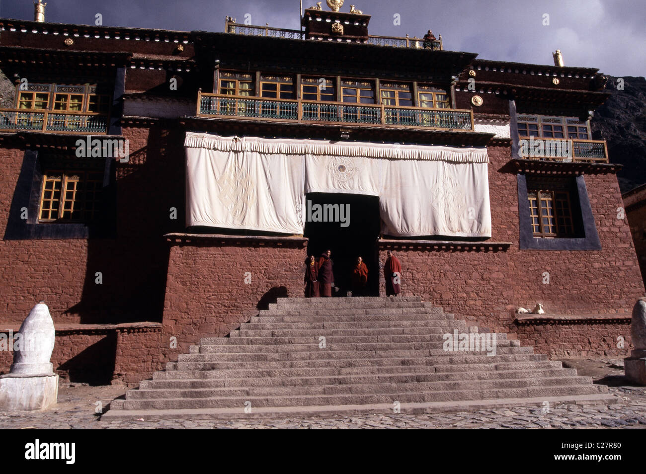 Tibetan Buddhist monks stand outside the Tsurphu Monastery in Tibet ...