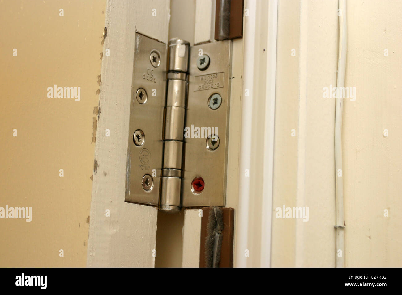 fitting a hinge onto a door frame Stock Photo - Alamy