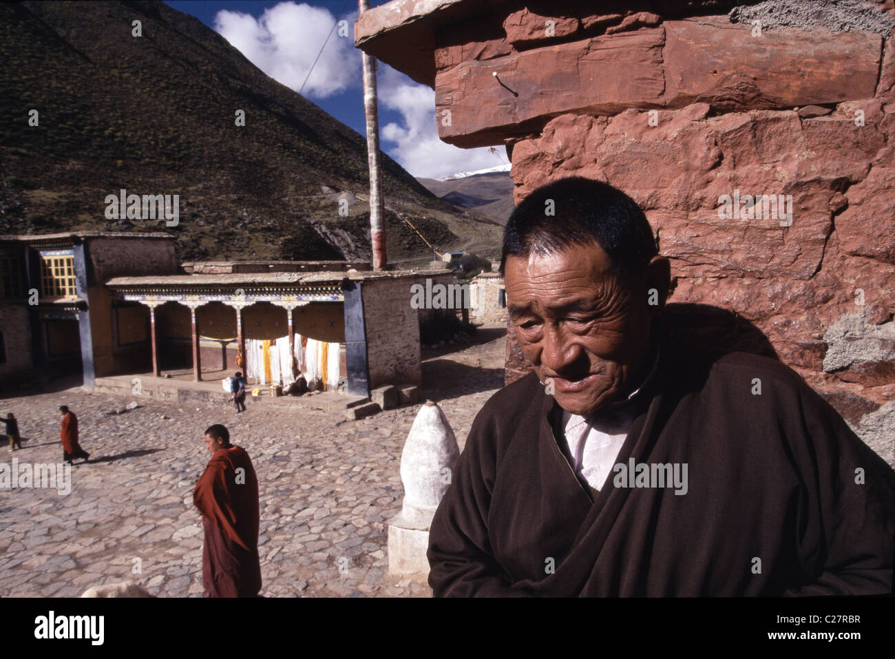 Tibetan Buddhist monks stand outside of the Tsurphu Monastery in Tibet ...