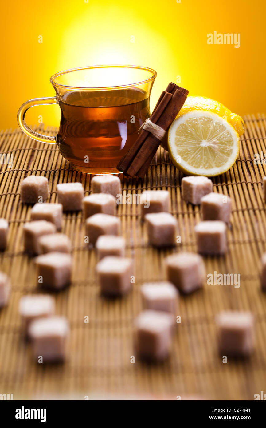 Hot tea over yellow background Stock Photo - Alamy