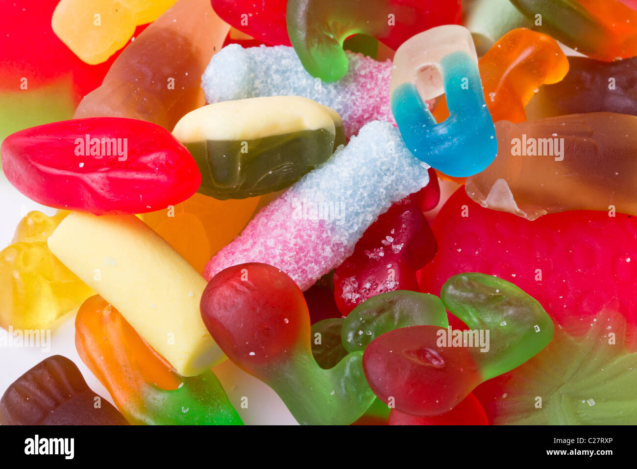 Kids vibrant multicoloured jelly sweet mix up background Stock Photo ...