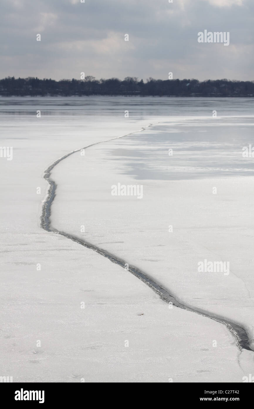 A split in the ice on a frozen lake Stock Photo - Alamy