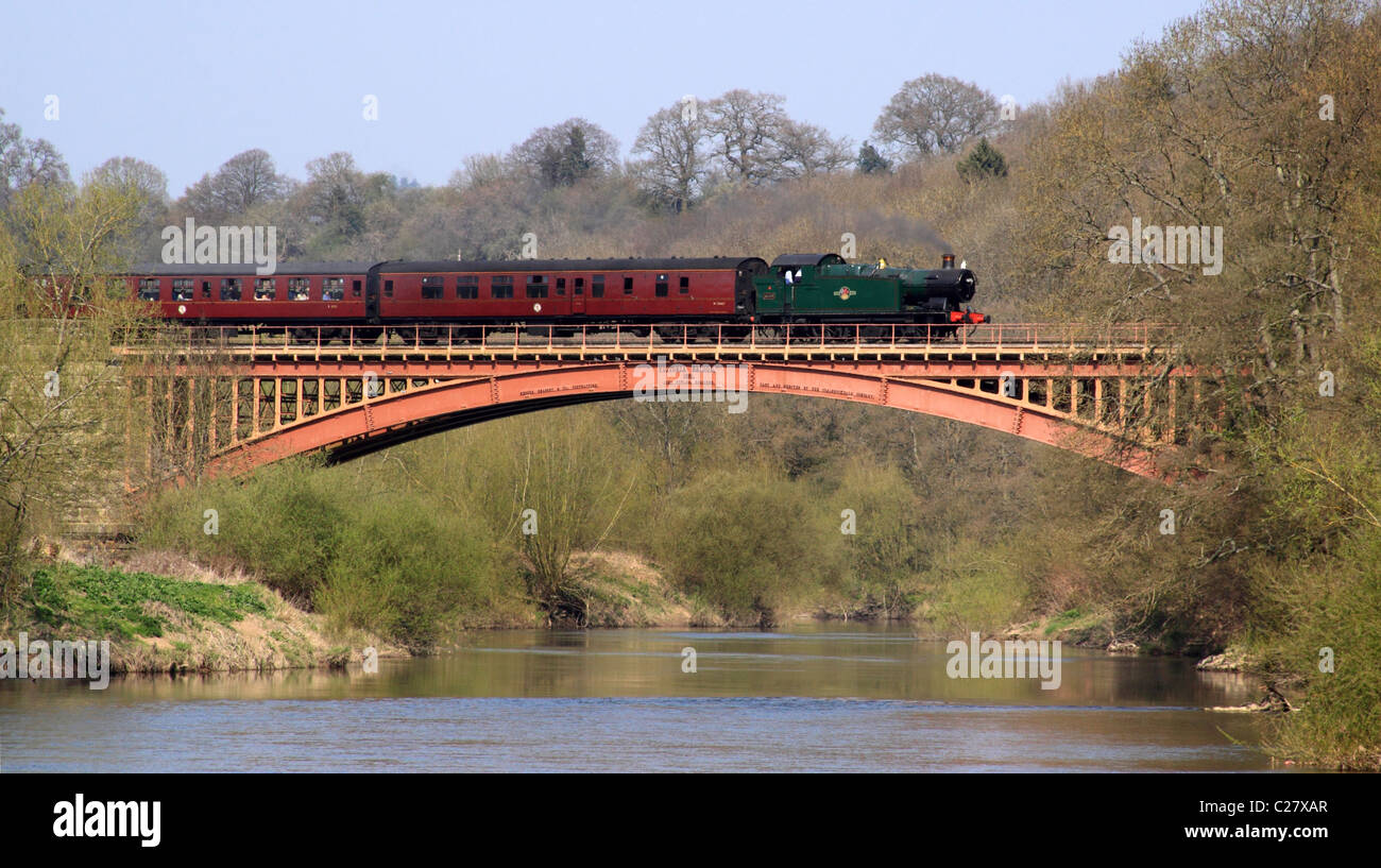A passenger steam locomotive passing over Victoria Bridge which crosses ...