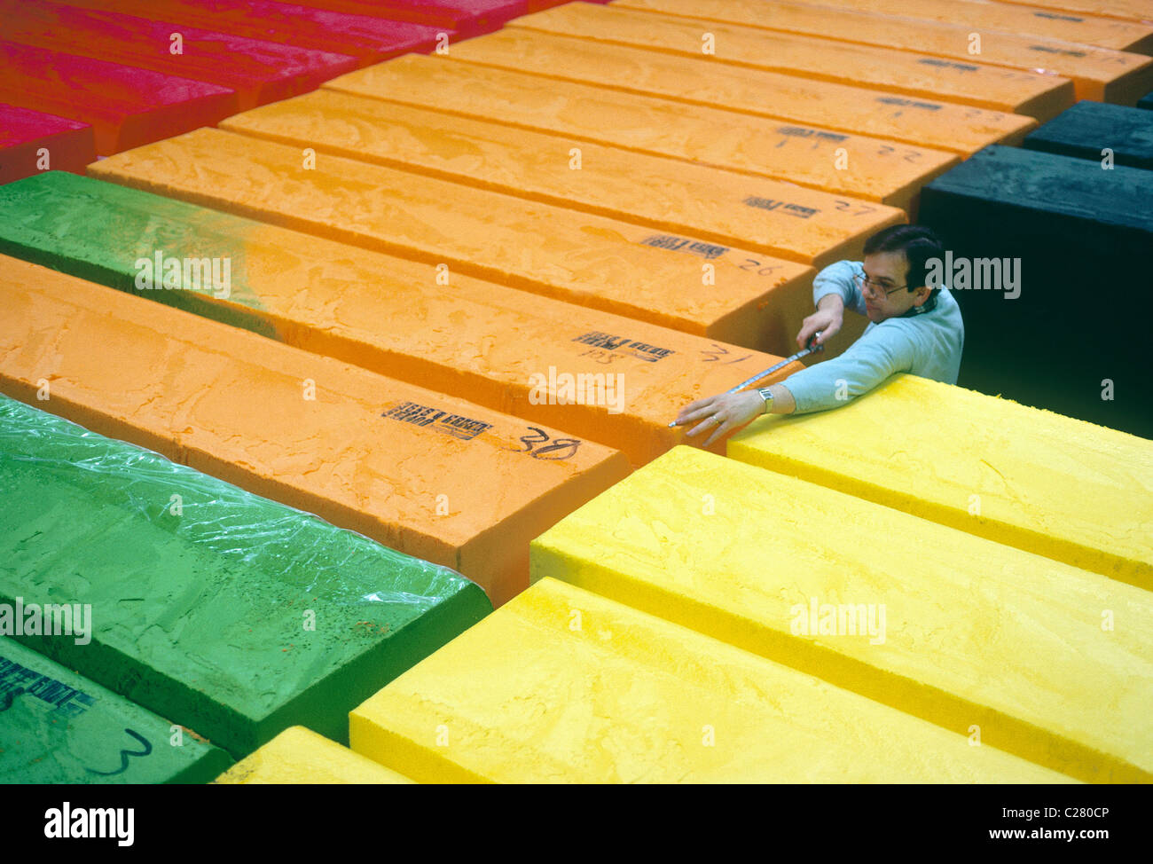 Worker performing a quality control check at a foam rubber ...