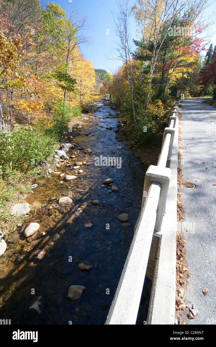 Bridge over river rushing through western Maine's White Mountains ...