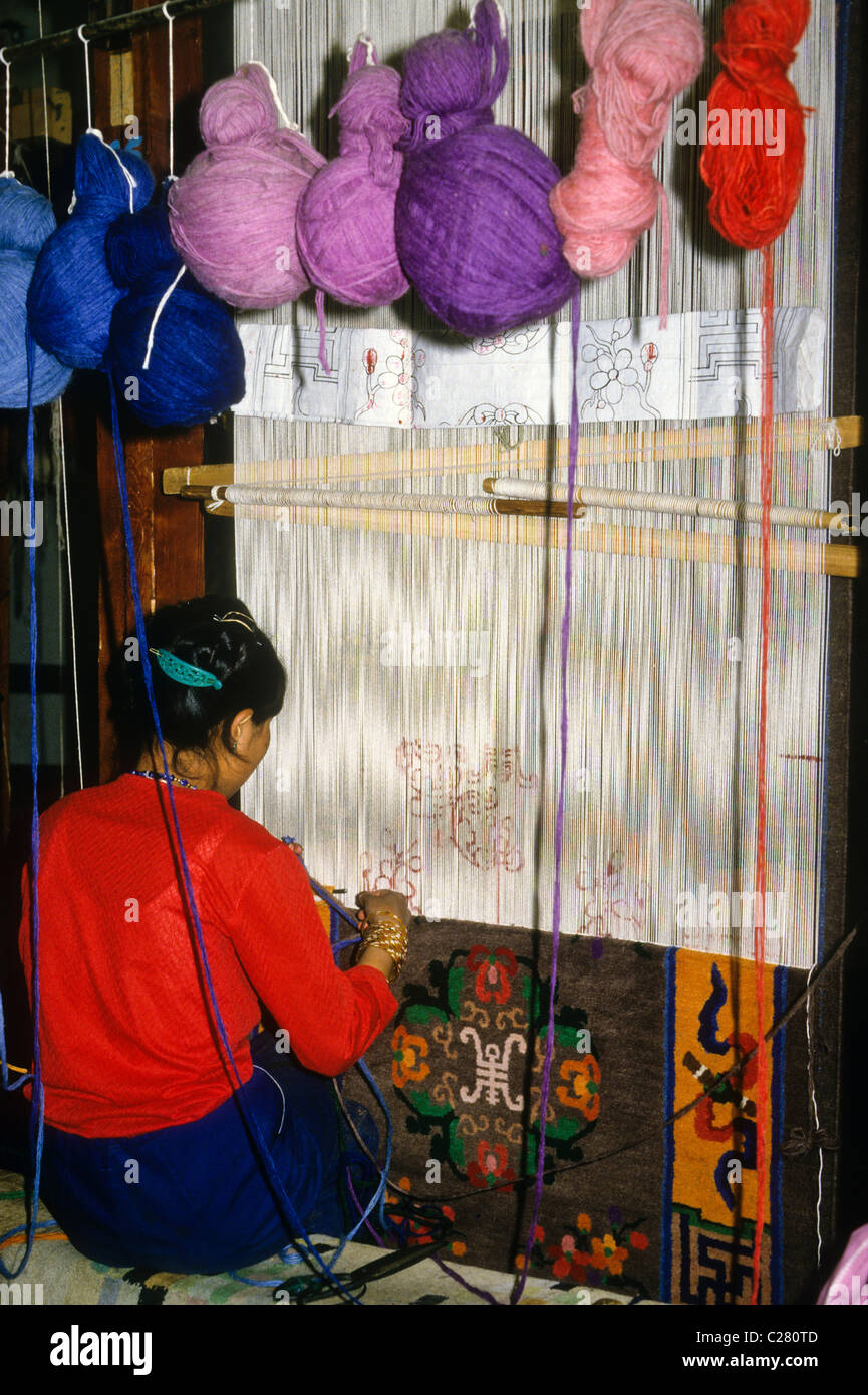 Woman weaving rug in carpet factory, Lhasa, Tibet, China Stock Photo ...