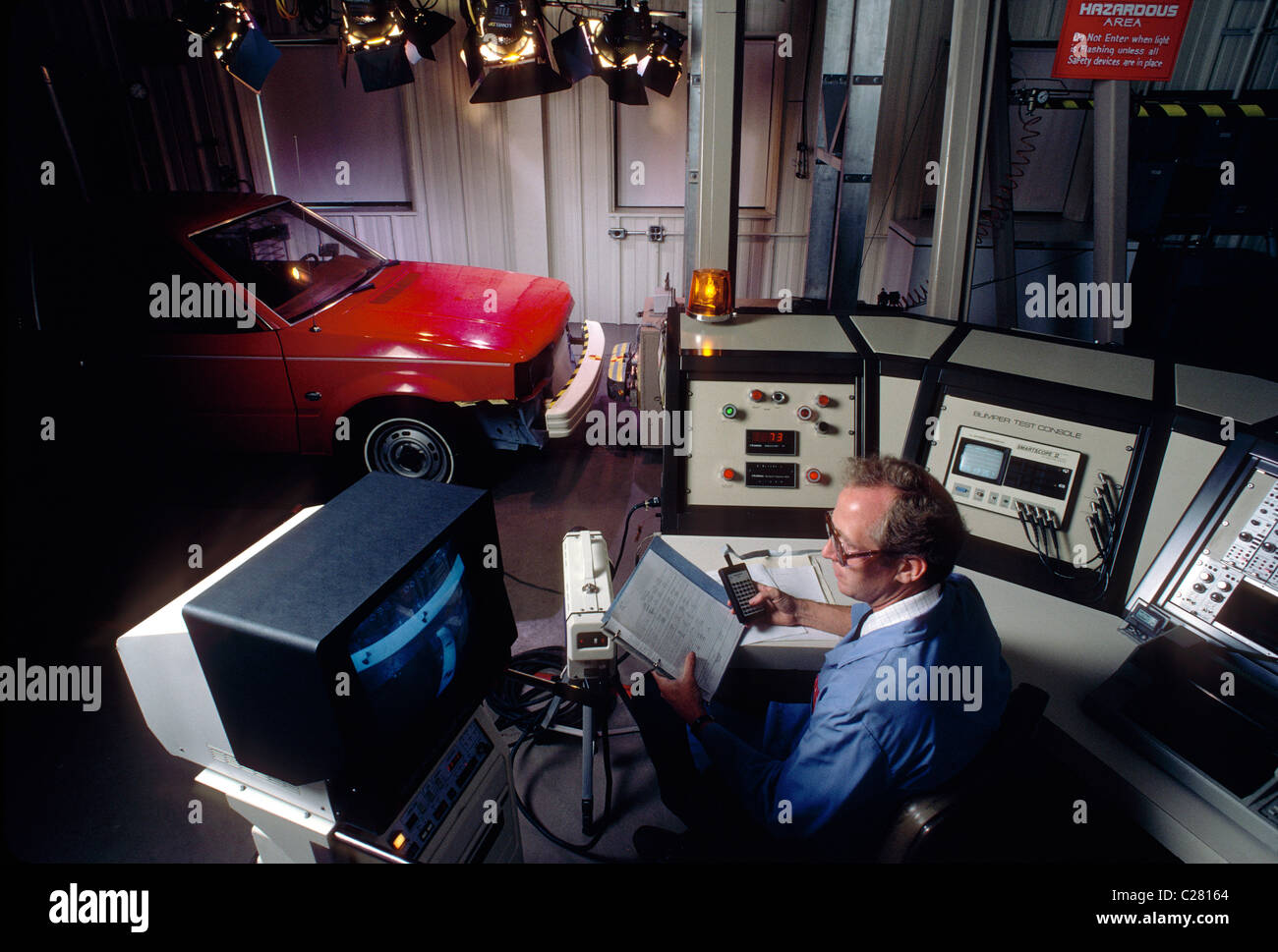 Male engineer performing an automobile bumper test in the laboratory of ...