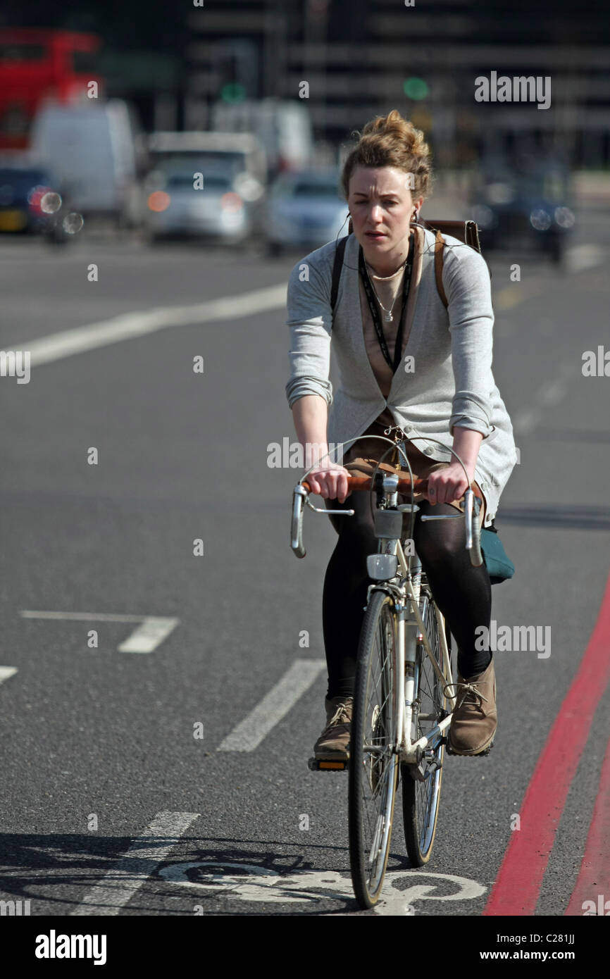 A lady cycling in sunshine in London, England Stock Photo - Alamy
