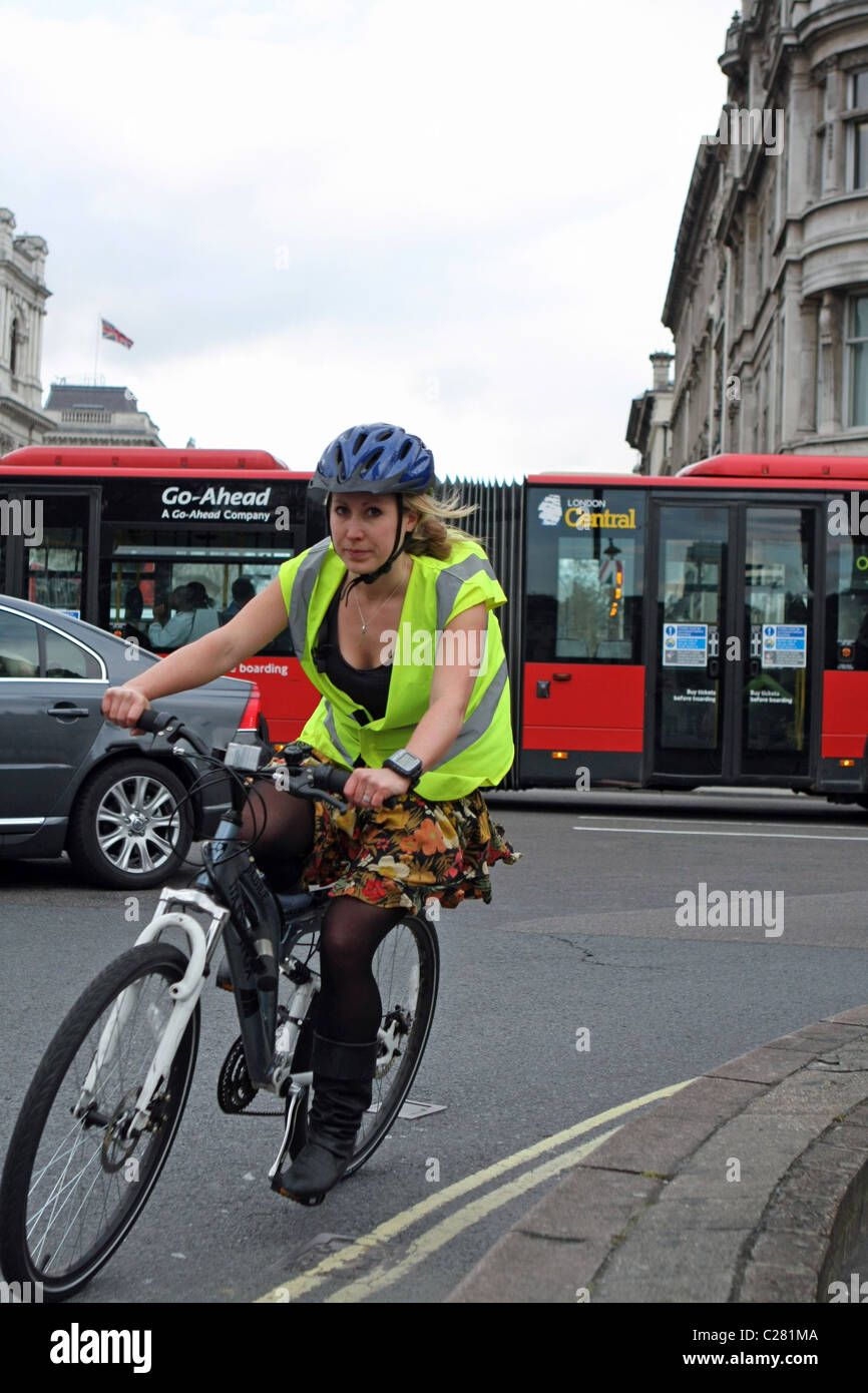 A lady cycling around a corner into Parliament Square, Westminster ...