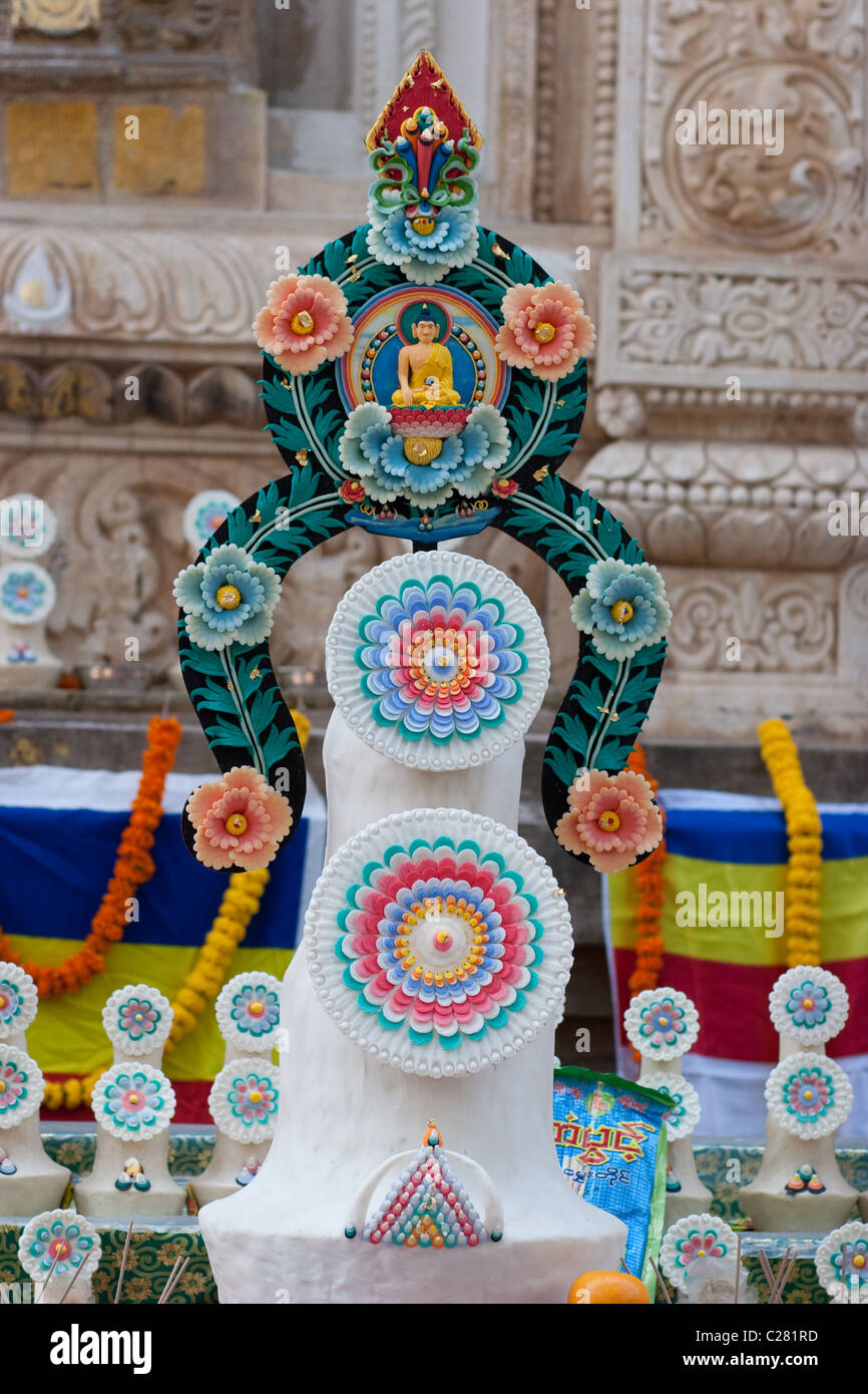 A flower made from wax and butter with an image of Buddha as an ...