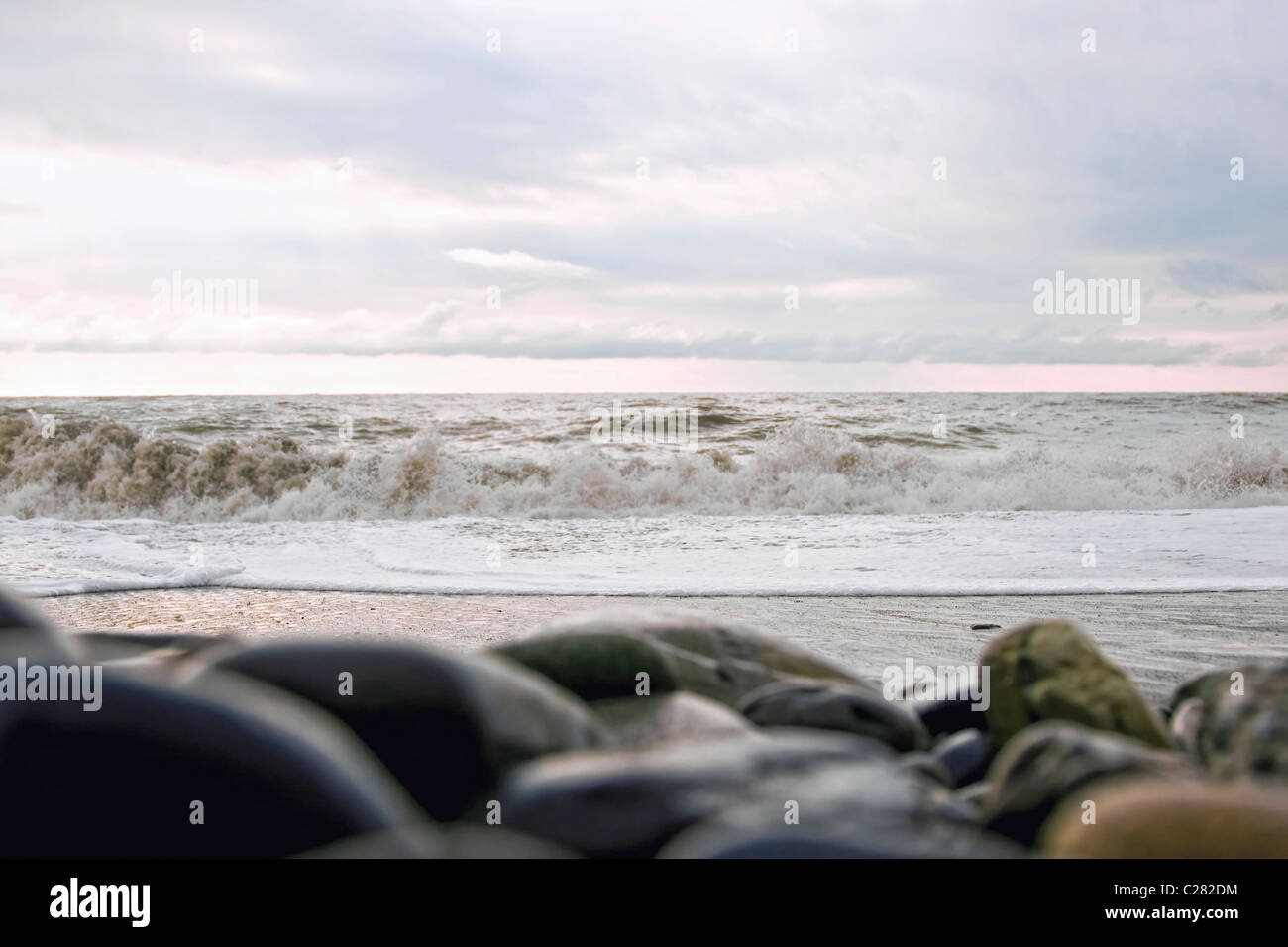 Wet stones on the beach in a storm closeup Stock Photo - Alamy