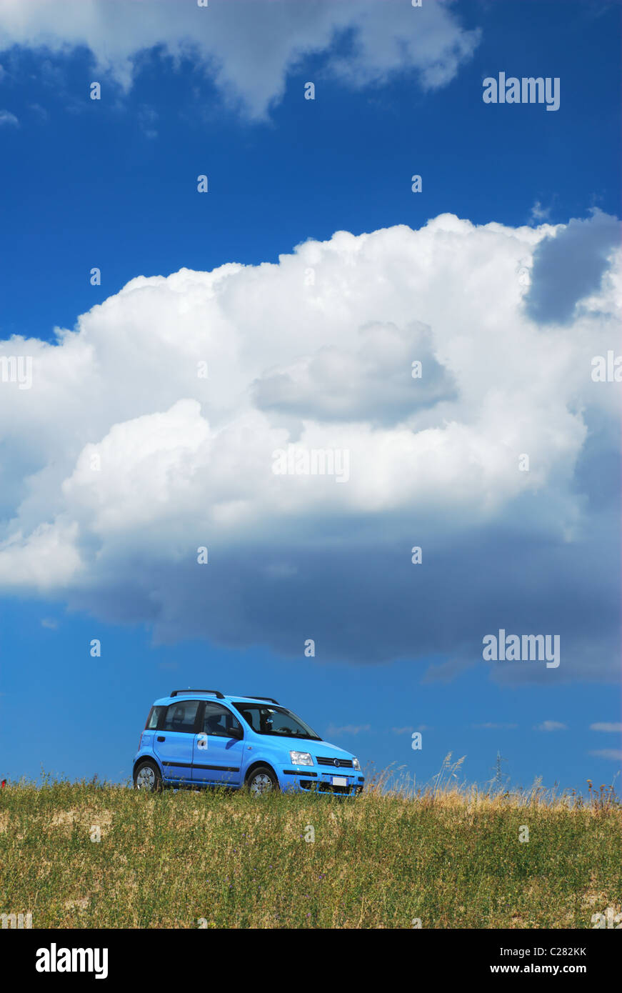 Bright pale blue modern car under white cloud and blue sky Stock Photo ...