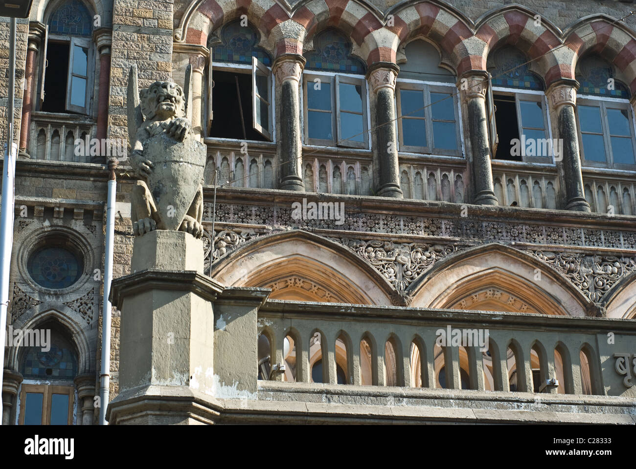Facade of a railway terminal in Mumbai. Winged lion with a shield ...