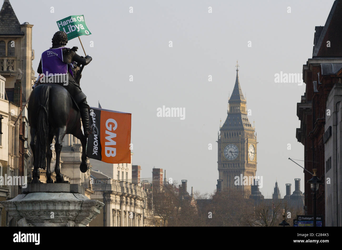 The statute of King Charles 1 is decorated with posters and banners ...