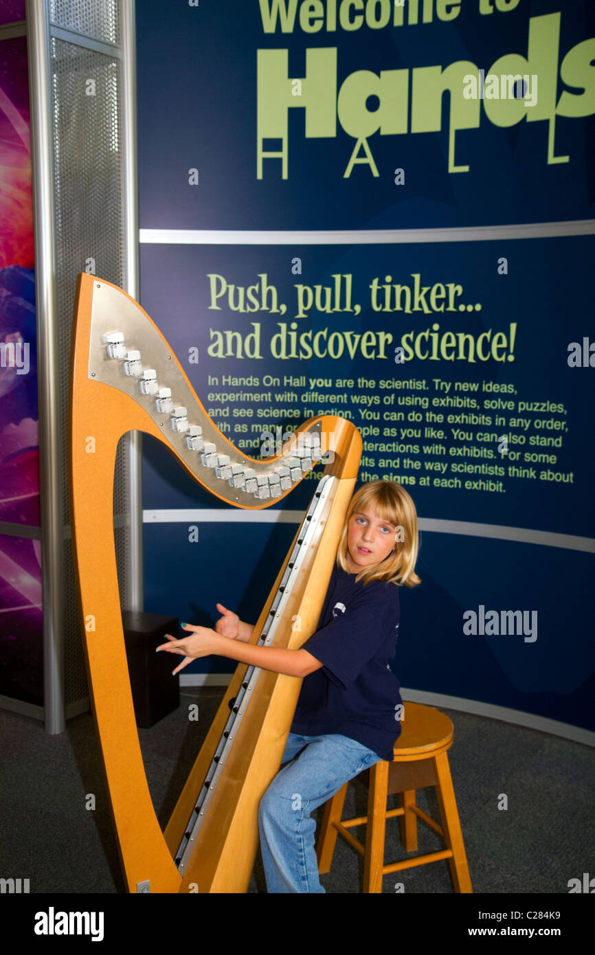 Child playing an electronic stringless harp at the Gulf Coast Exploreum ...